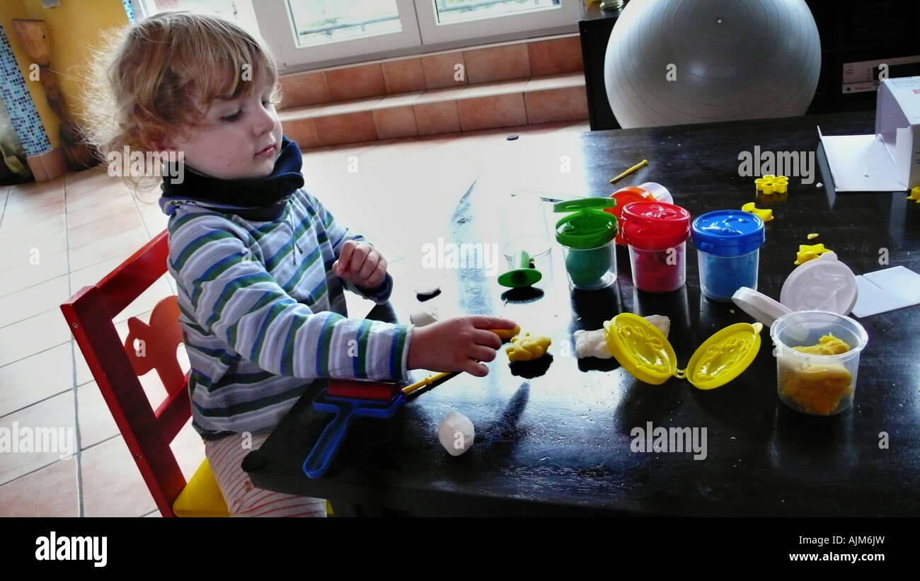 small boy playing with modeling clay Stock Photo - Alamy