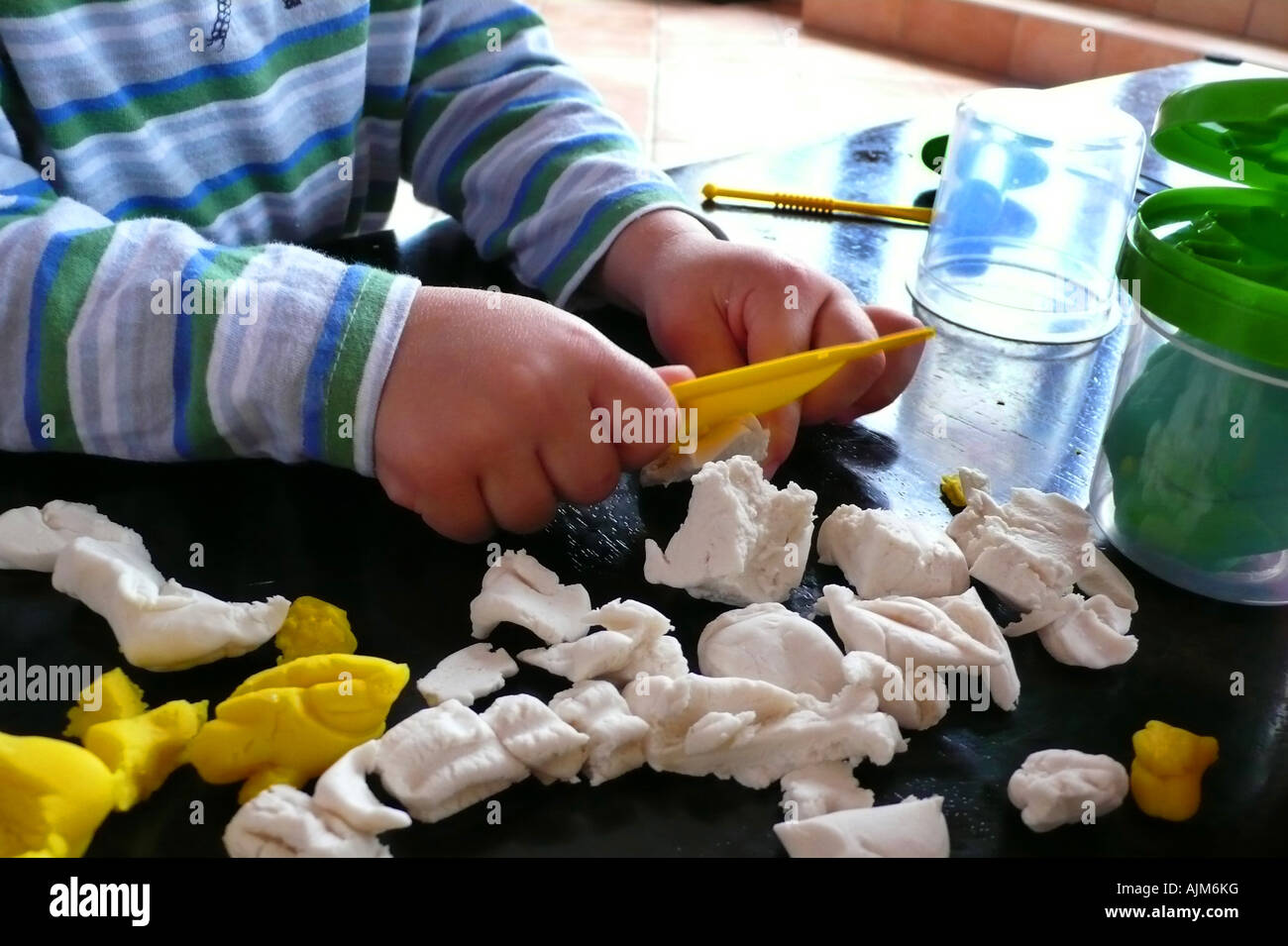 small boy playing with modeling clay Stock Photo - Alamy