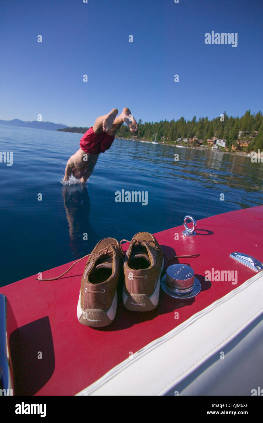 A man diving off a power boat into Lake Tahoe CA Stock Photo - Alamy
