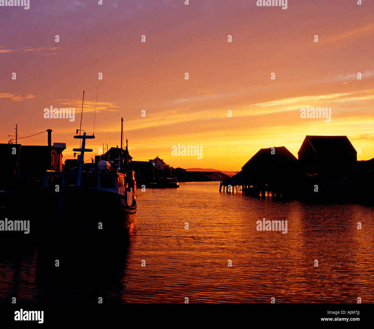 Sunset on fishing harbor Stock Photo - Alamy