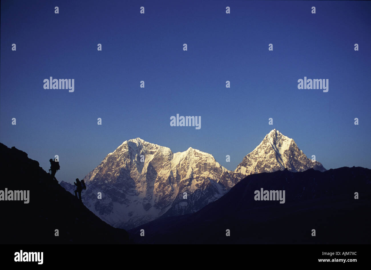 A couple trekking towards Mount Everest near the village of Lobuche ...