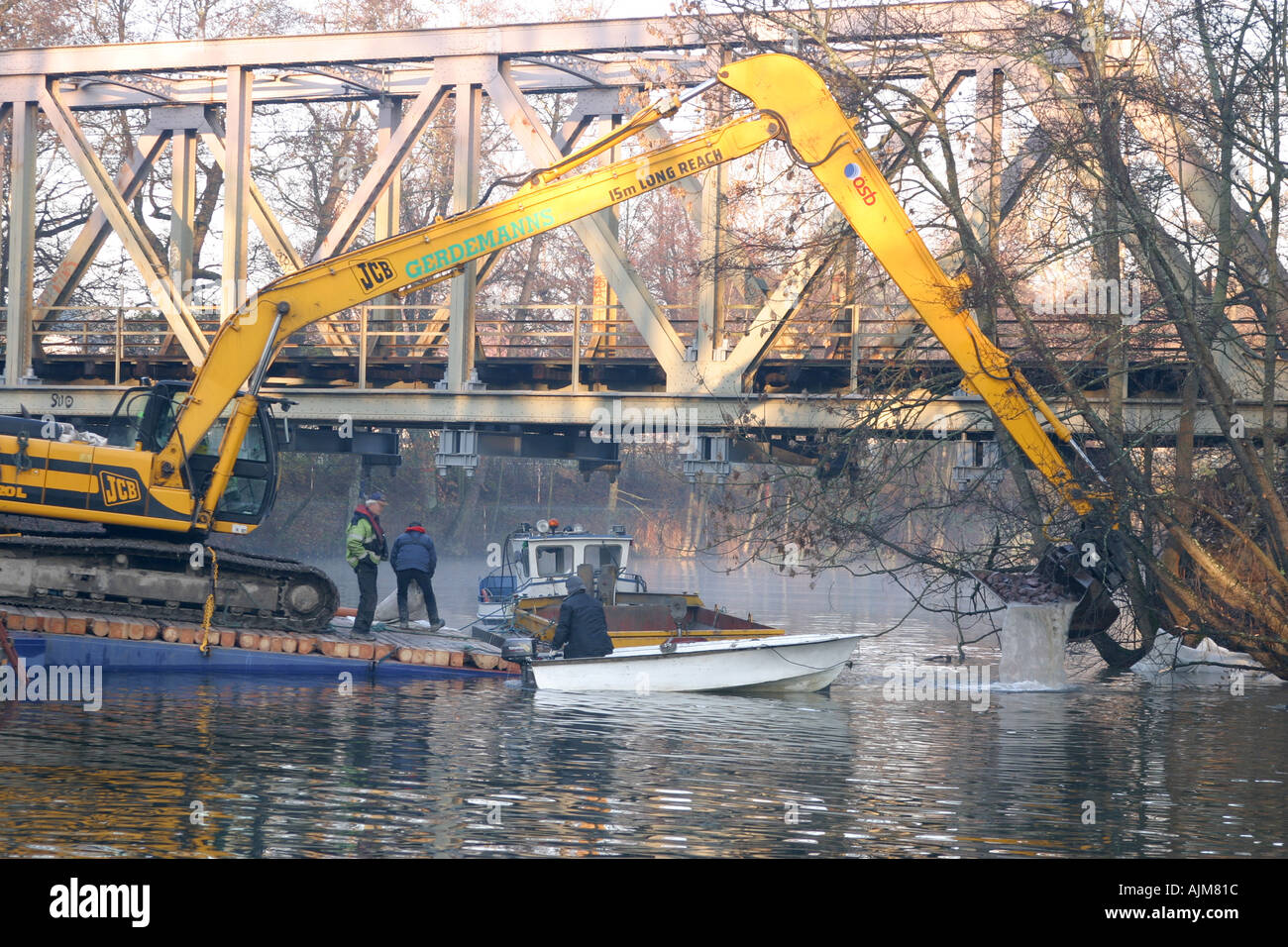 Floating excavator digging in a river Stock Photo - Alamy