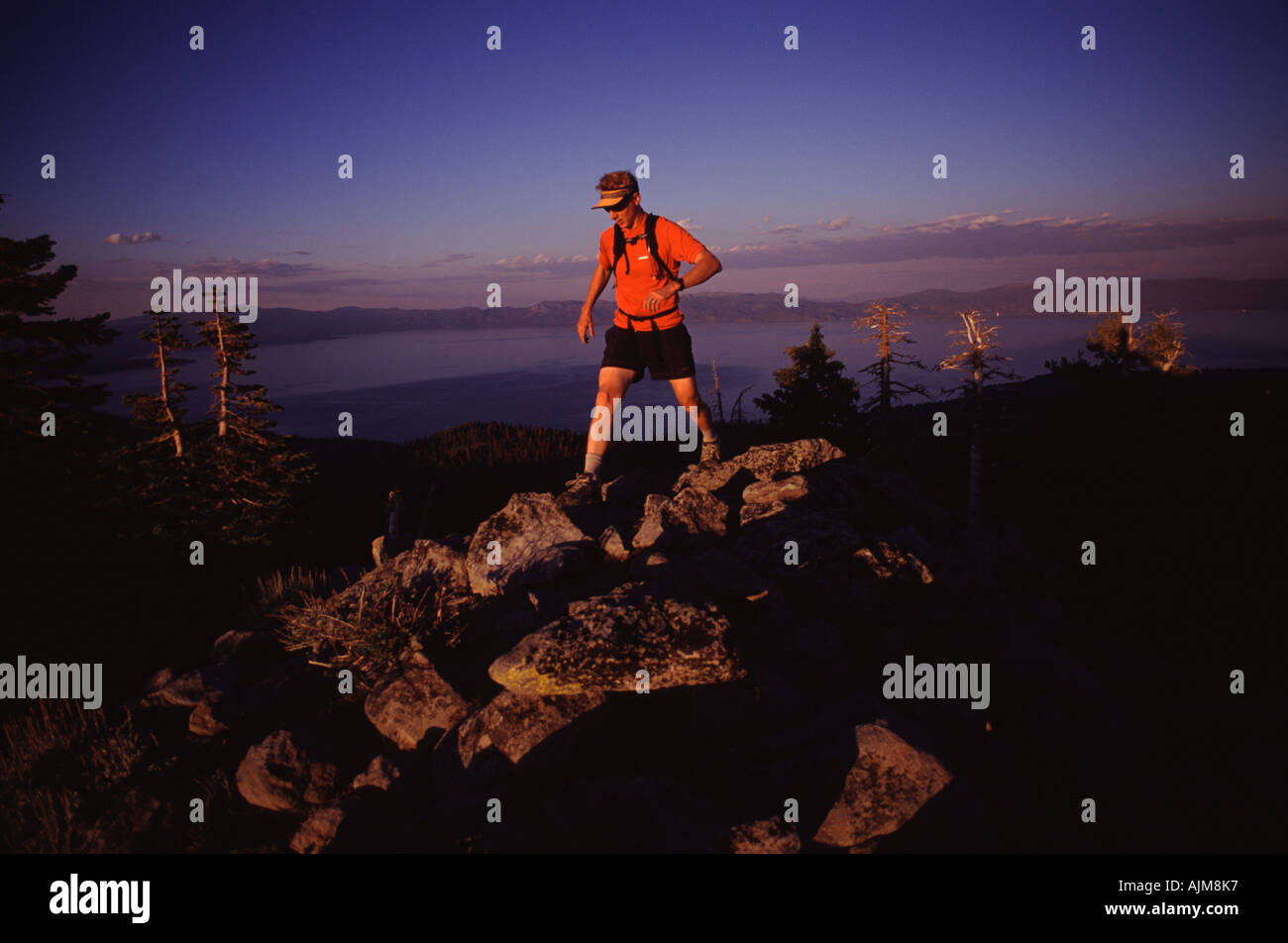 A man running above Lake Tahoe CA Stock Photo - Alamy