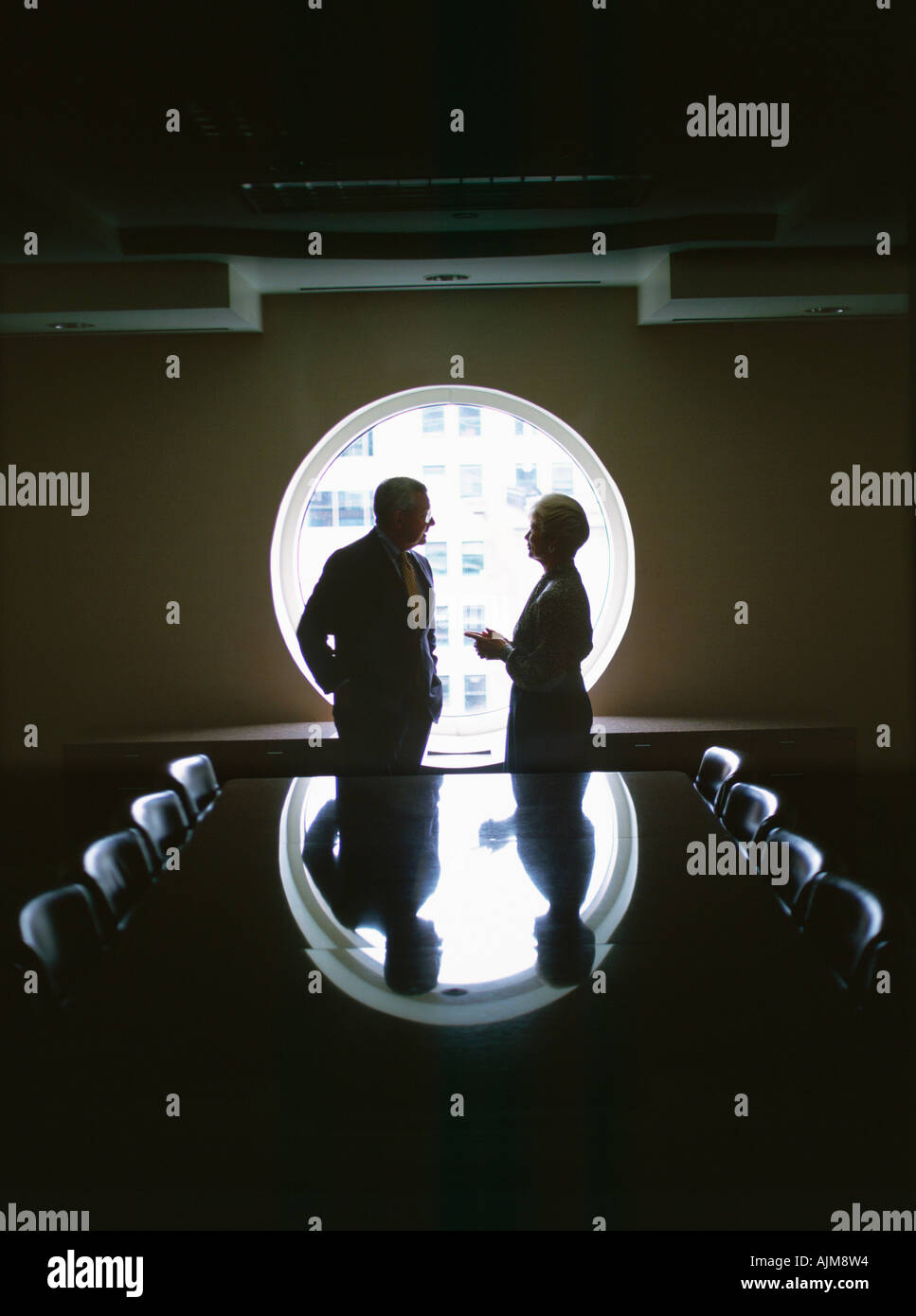 Two executives talking in a conference room Stock Photo - Alamy