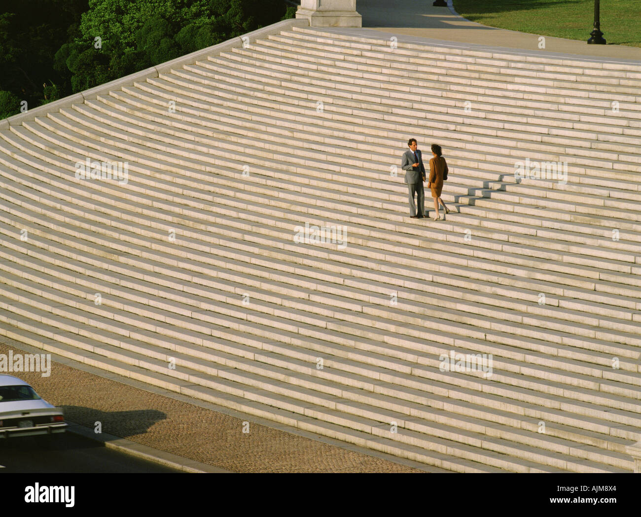 Two business people talking on steps Stock Photo - Alamy