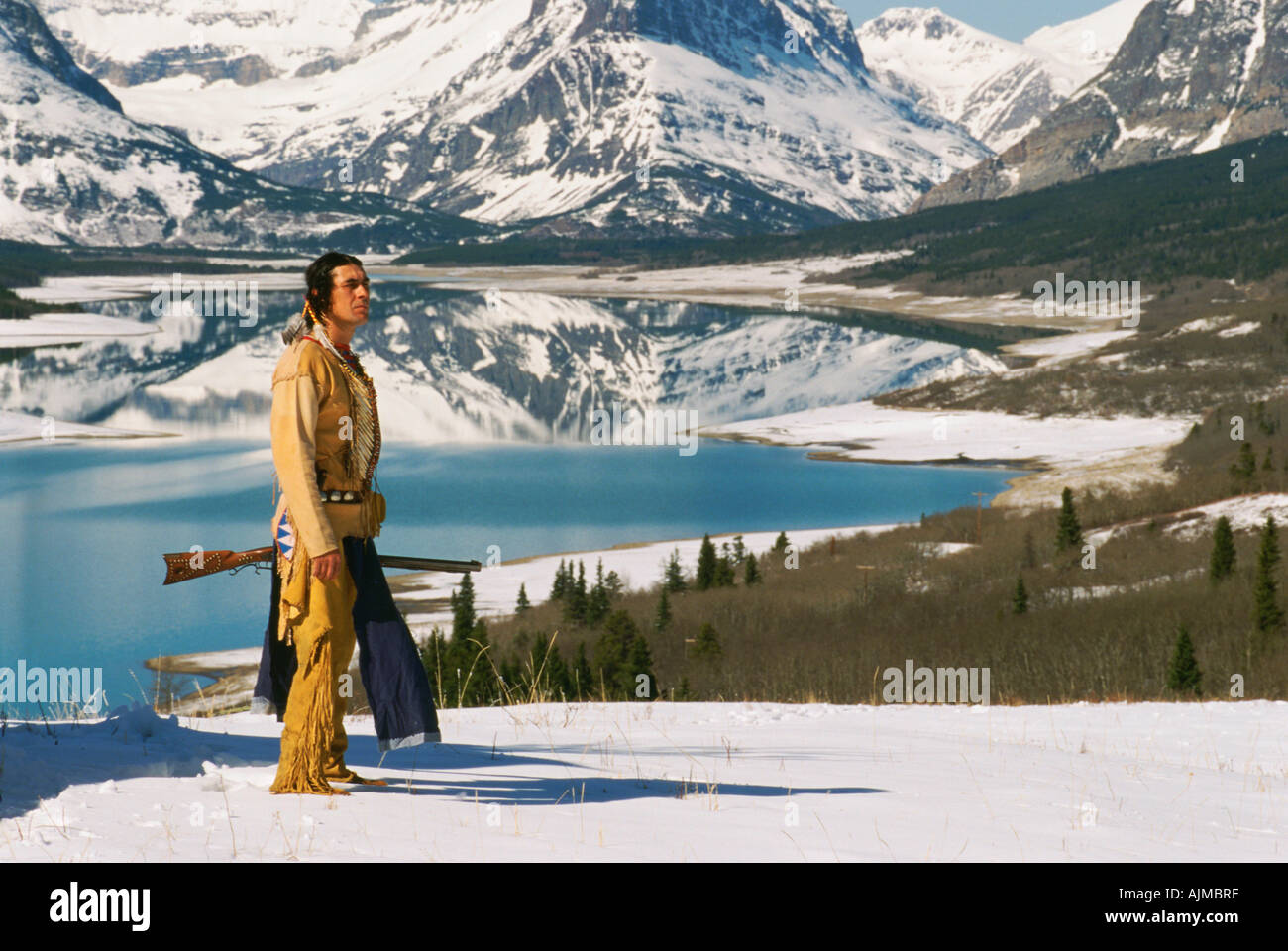 Native American with rifle Glacier national Park Montana Stock Photo ...