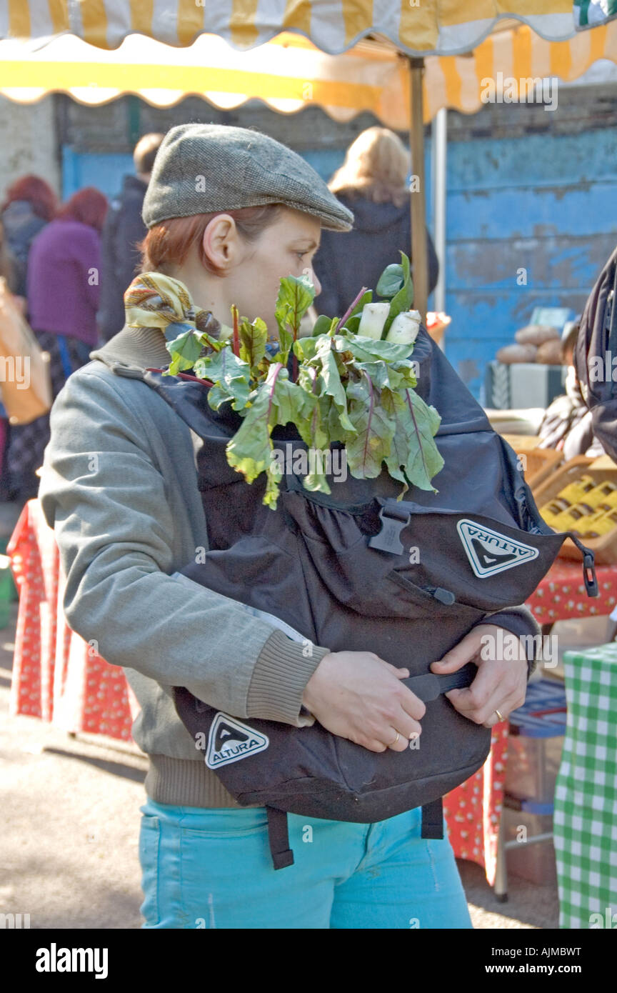 Girl carrying pannier full of vegetables Islington Farmers Market ...