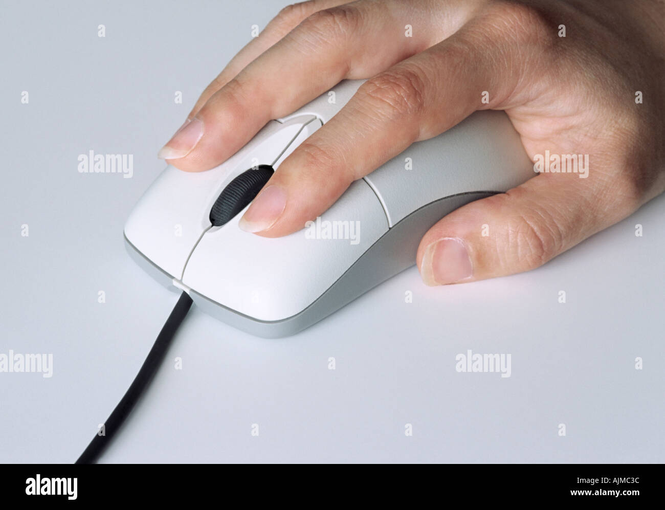 Hand on White and Grey Computer Mouse Stock Photo - Alamy