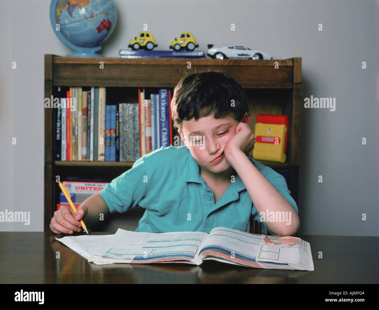 Young boy doing his homework Stock Photo - Alamy