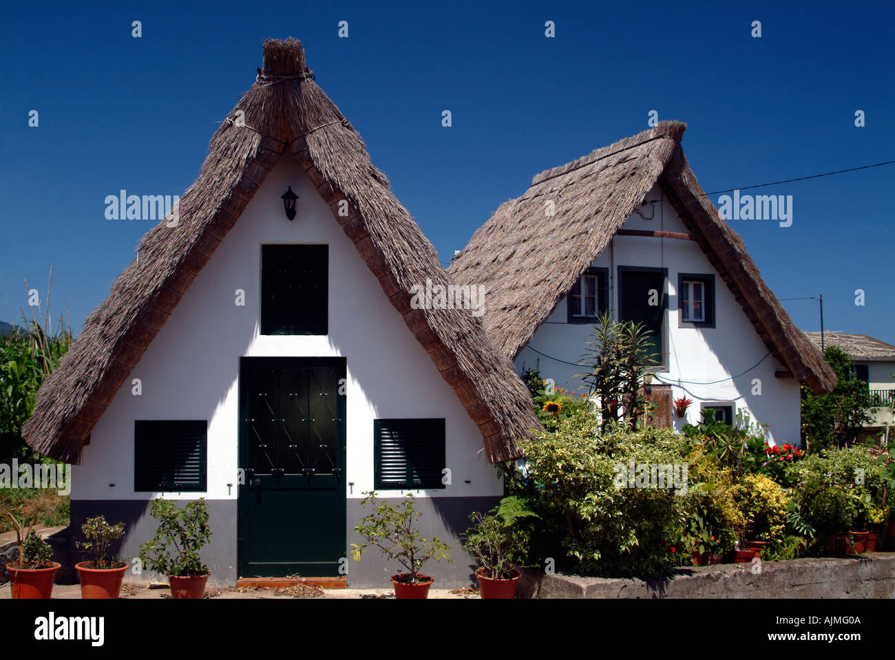 Typical Palheiros, Triangular shaped cottages in the Portugese island ...