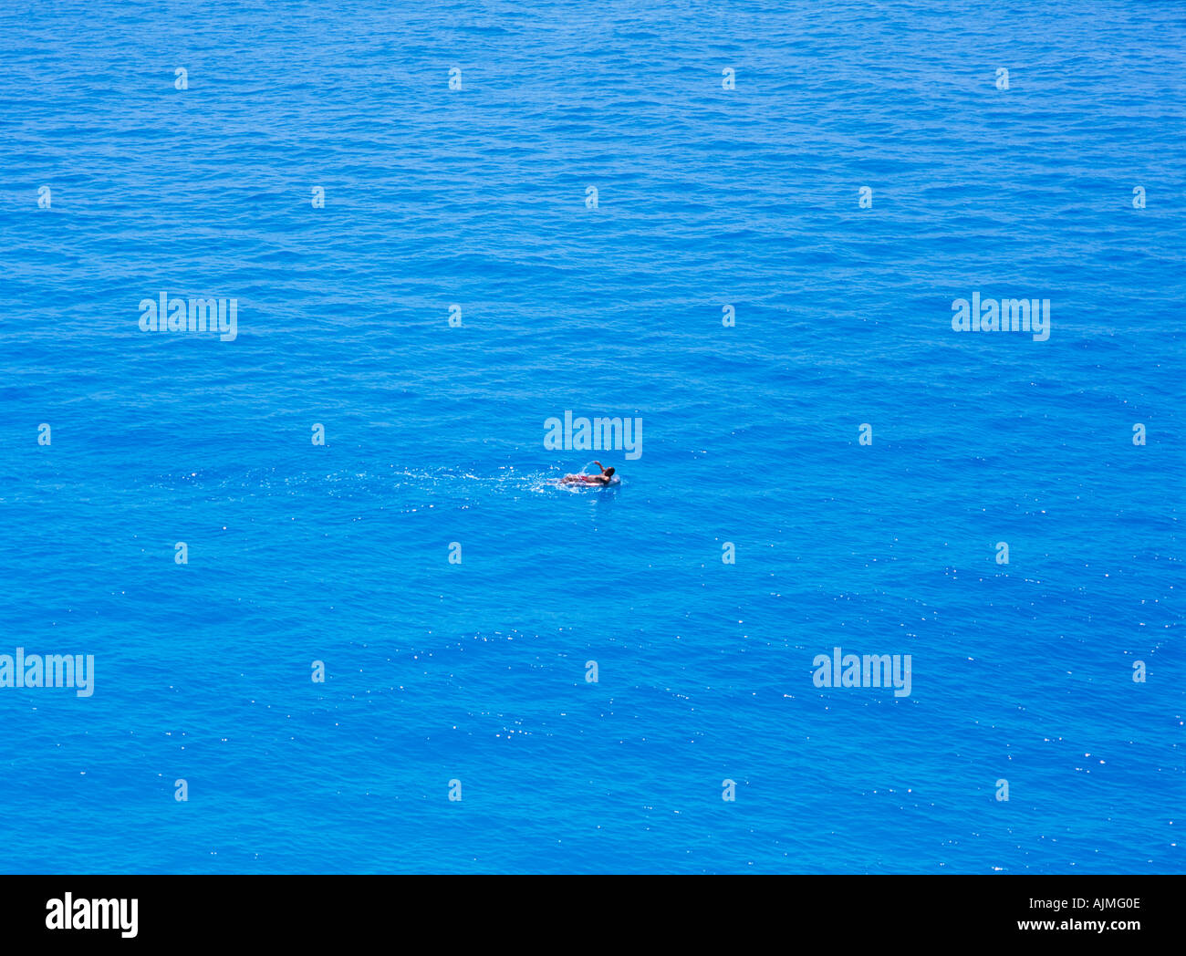 Swimmer in far distance Stock Photo - Alamy