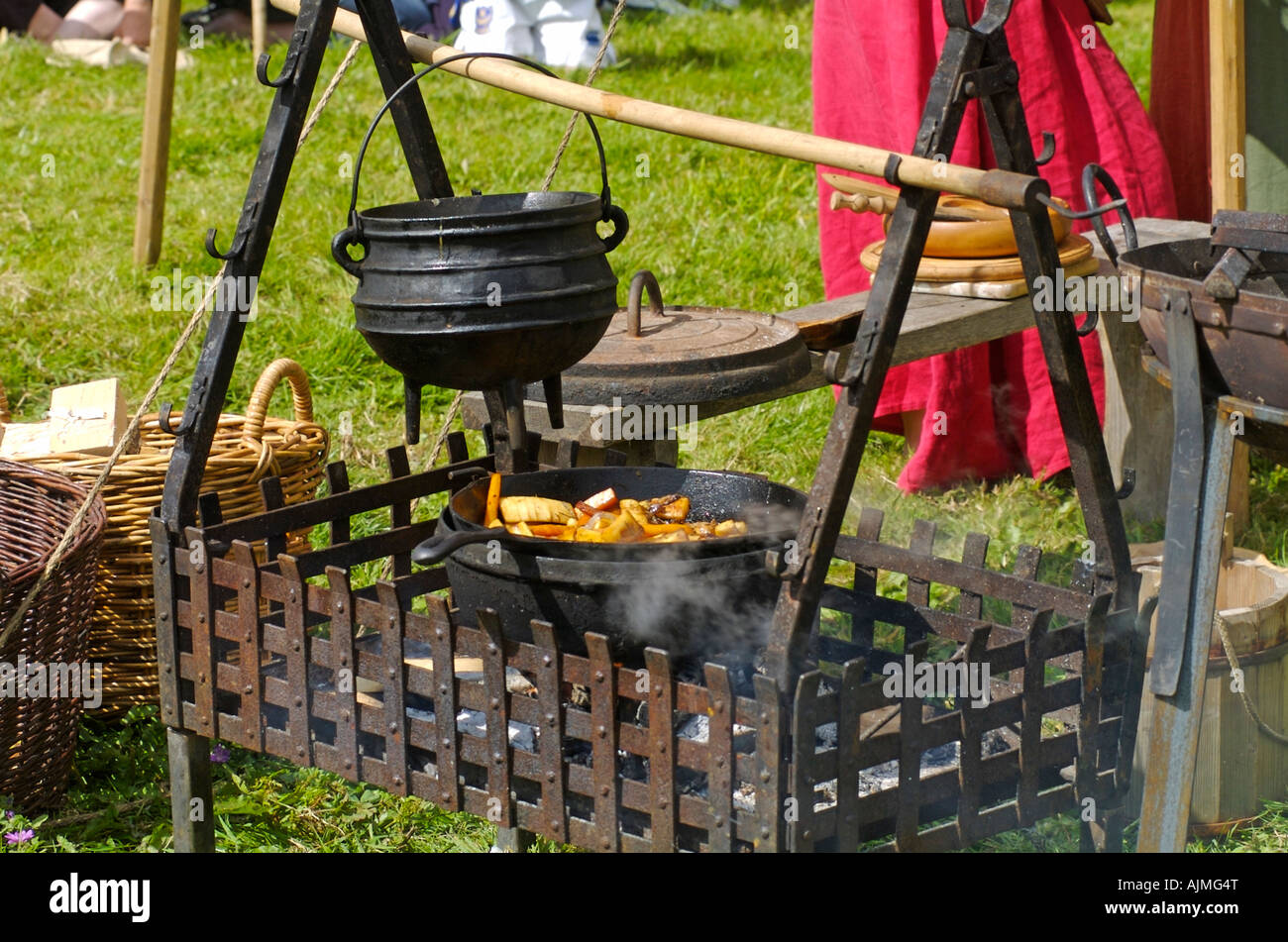 Black Cooking pot shown during medieval feasting Stock Photo - Alamy