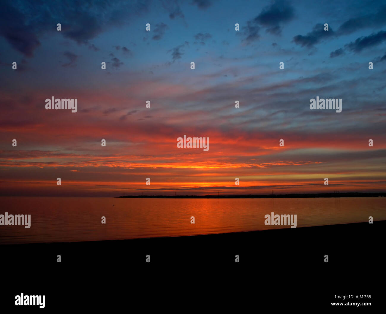 Dramatic colors and sky in sunset over the limfjord Denmark western ...
