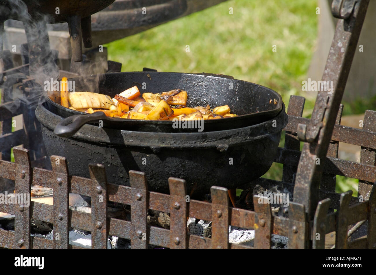 Black Cooking pot shown during medieval feasting Stock Photo - Alamy