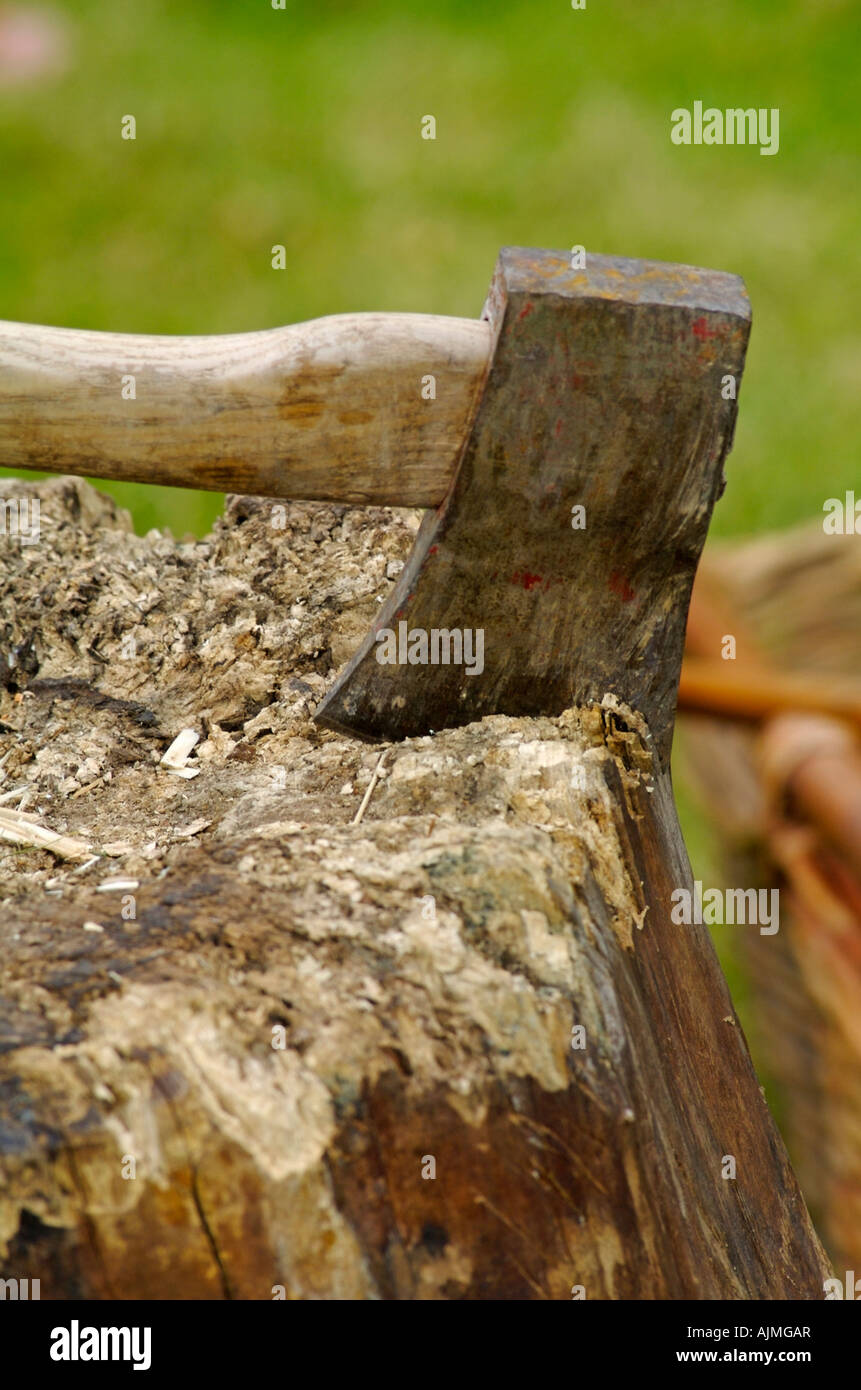 Axe in a block of wood shown during medieval feasting Stock Photo - Alamy