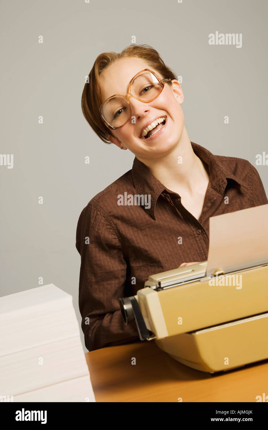 Office worker using typewriter at desk Stock Photo - Alamy
