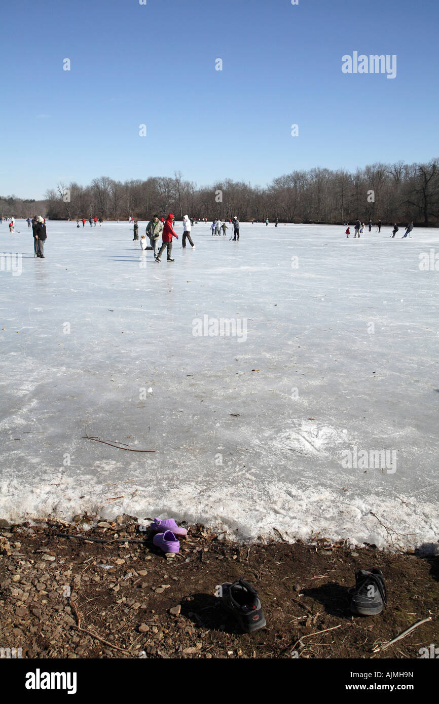 The edge of the ice with two pairs of shoes waiting for return some of ...