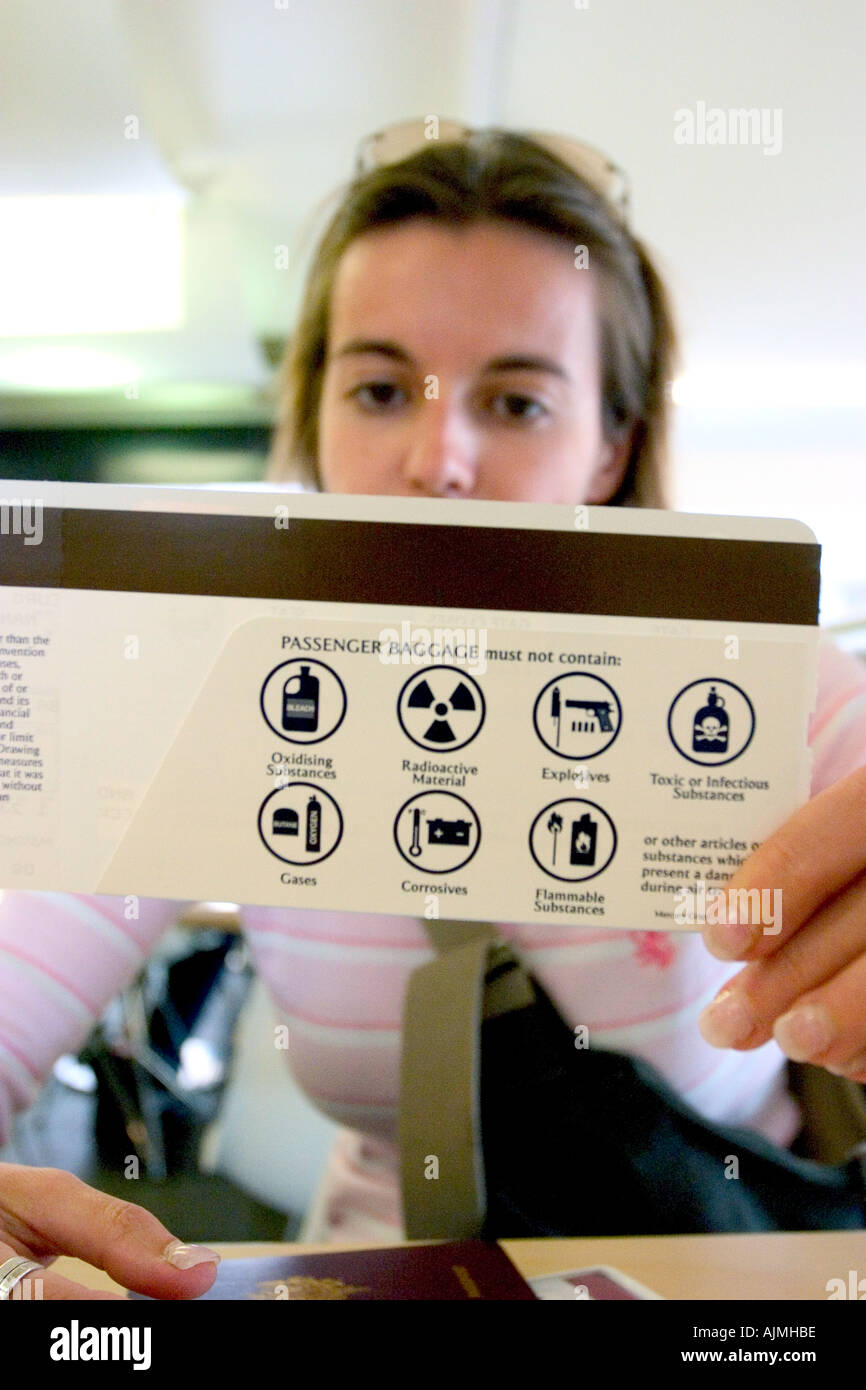girl reading her airplane ticket before boarding and security ...