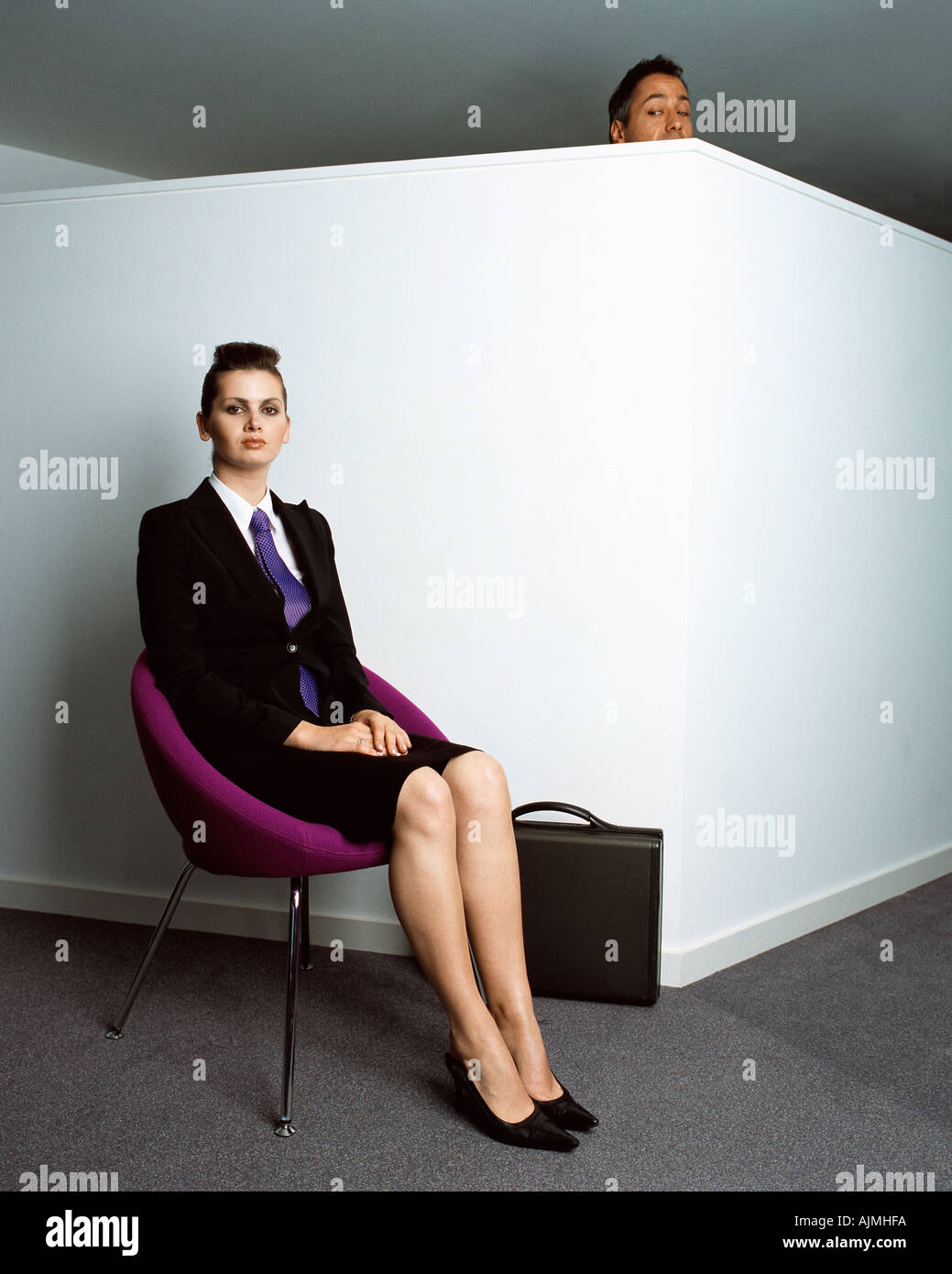 Man peering at businesswoman Stock Photo - Alamy