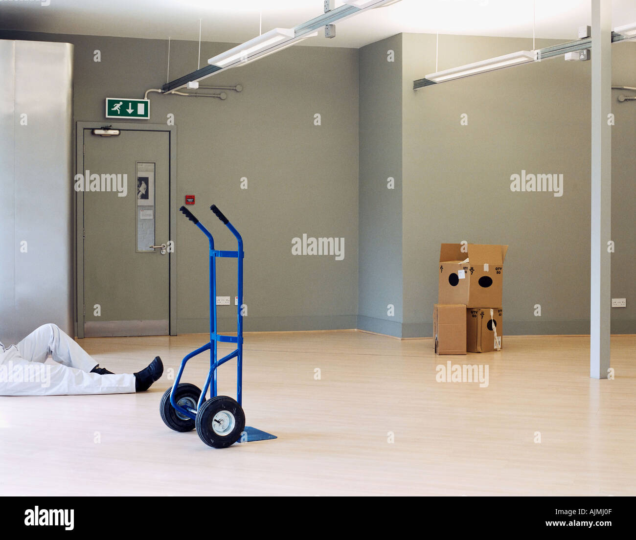 Janitor relaxing in office Stock Photo - Alamy