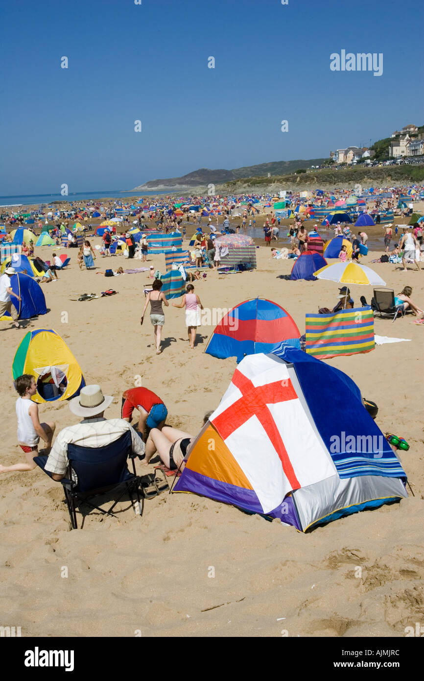 Holidaymakers with tents one with English flag on crowded beach crowded ...