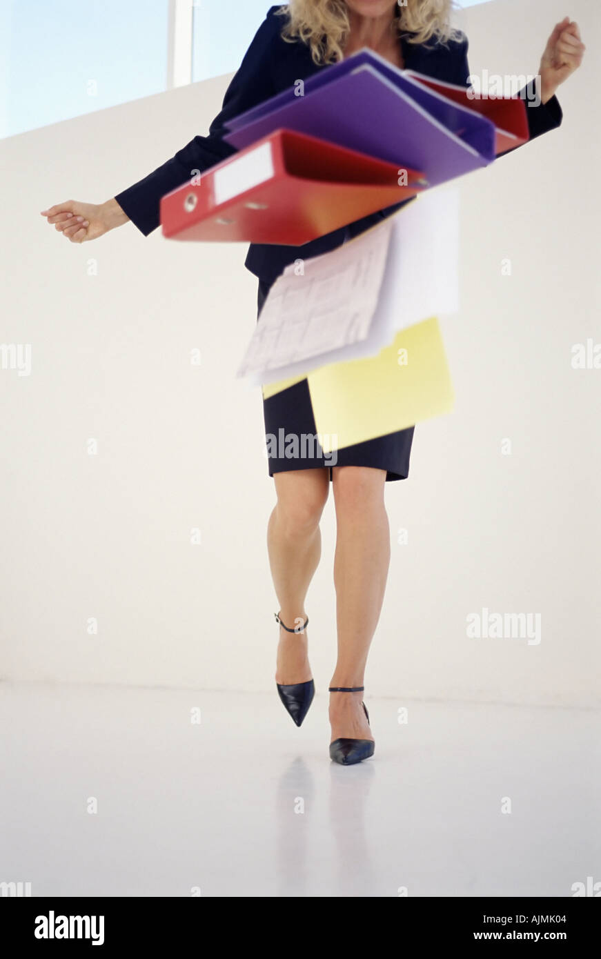 Woman dropping folders Stock Photo - Alamy