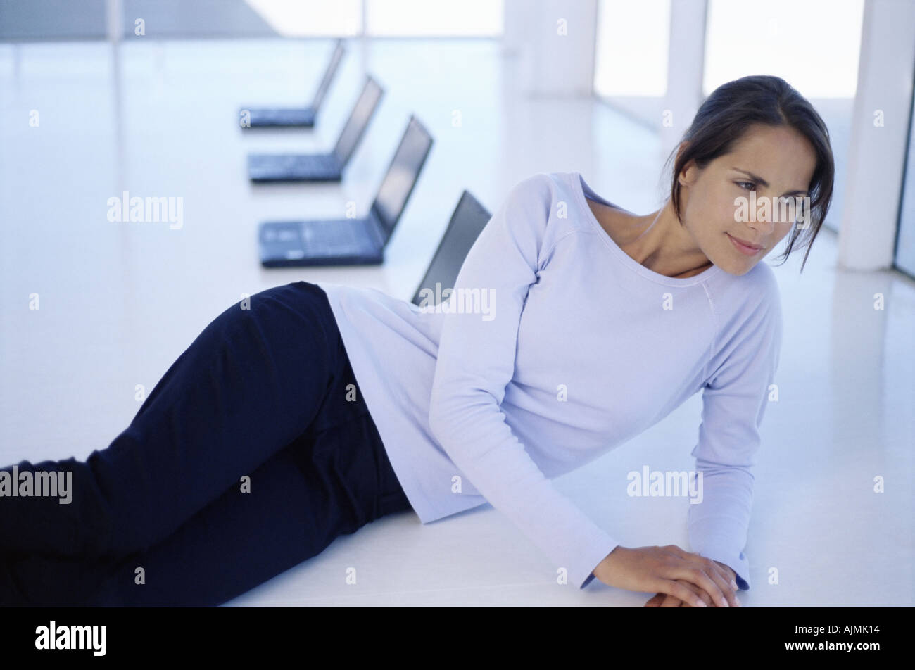 Woman lying on desk Stock Photo - Alamy