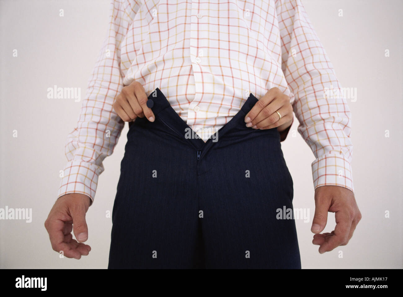 Woman undoing man's trousers Stock Photo - Alamy