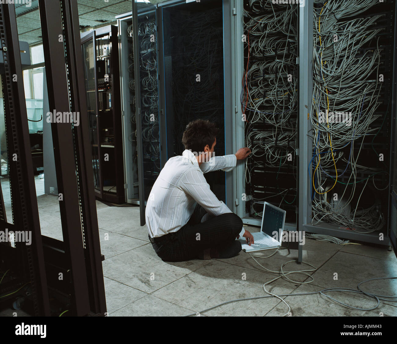 Man adjusting electrical cables Stock Photo - Alamy