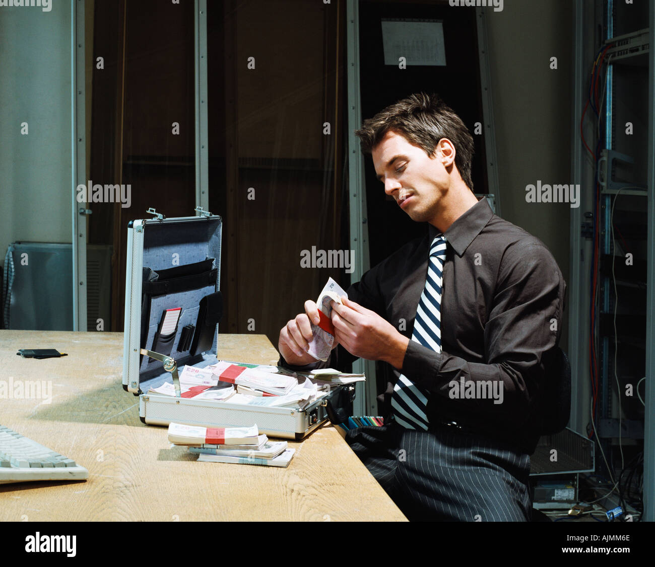 Man counting bundles of money Stock Photo - Alamy