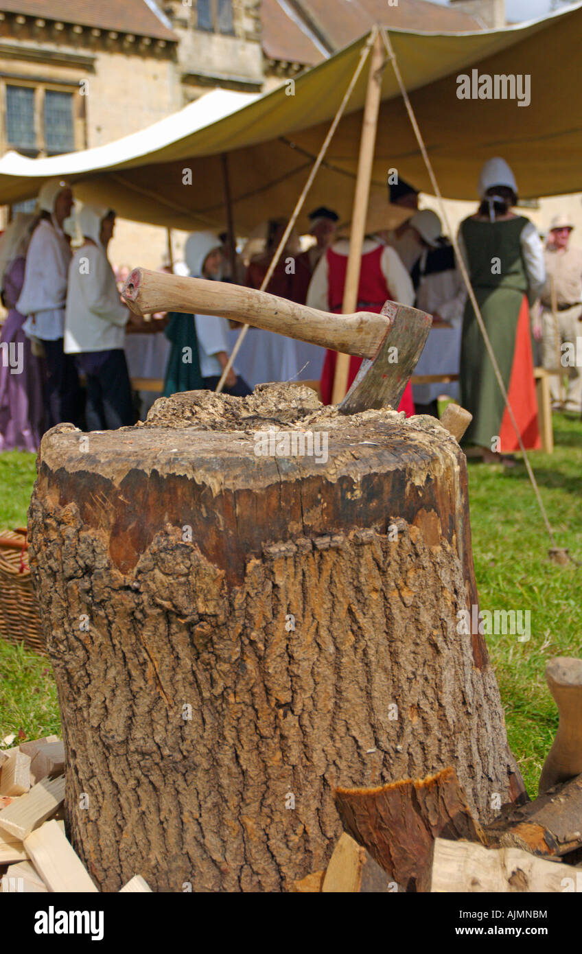 Axe in a block of wood shown during medieval feasting Stock Photo - Alamy
