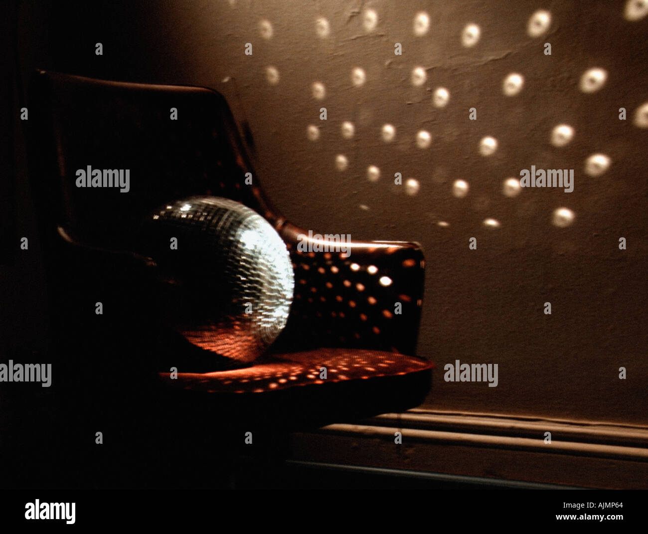 Disco ball on leather armchair Stock Photo - Alamy