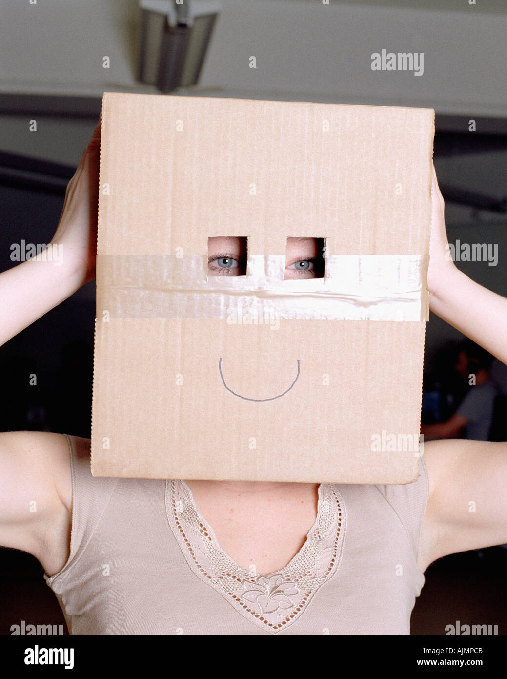 Woman wearing a cardboard box on head Stock Photo - Alamy