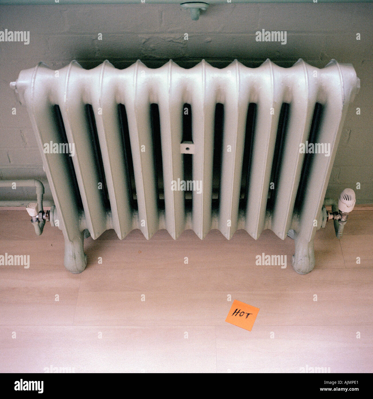 Adhesive note near radiator Stock Photo - Alamy