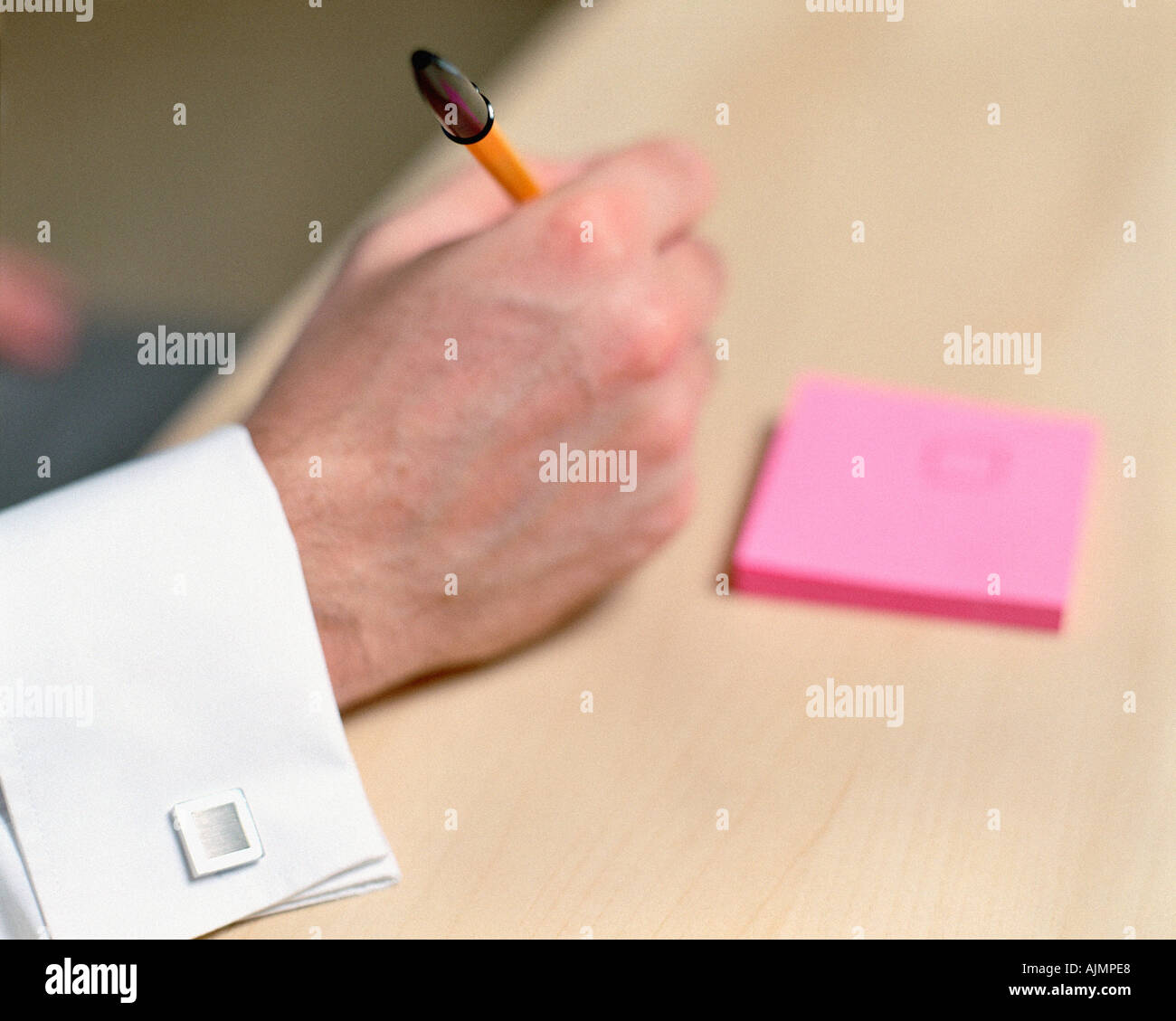 Man writing on square pad Stock Photo - Alamy