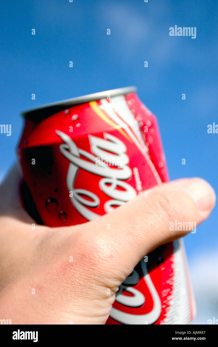hand and fingers of man with can of coca cola in the blue sky Stock ...