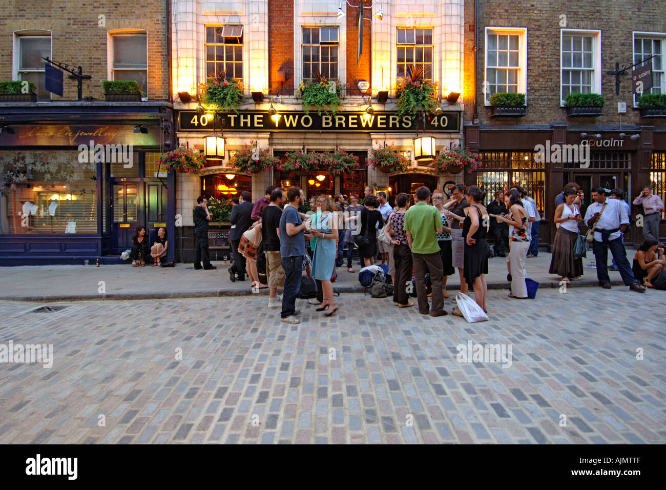 Patrons drinking outside the Two Brewers pub in Covent Garden in London ...