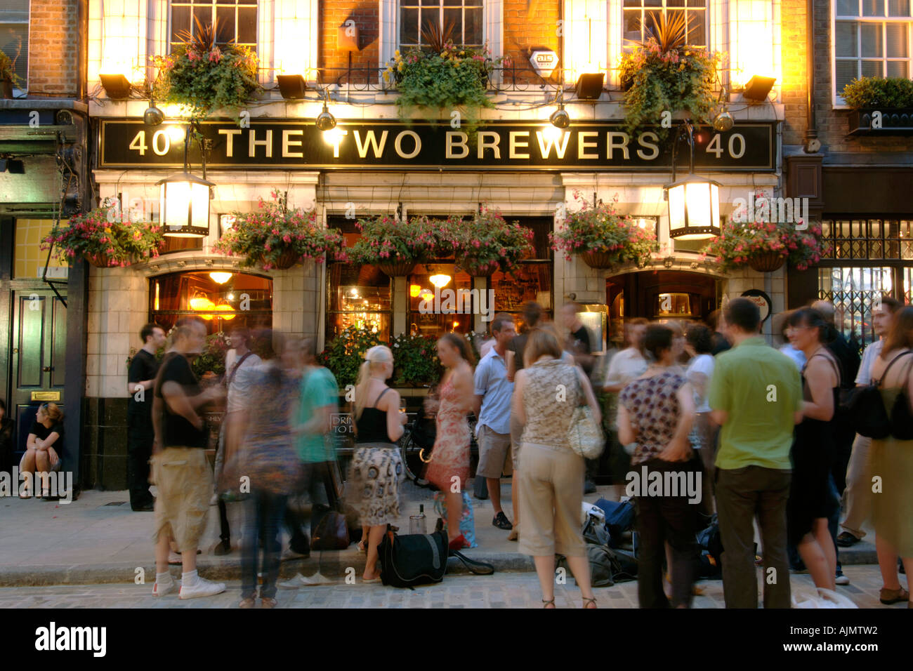 Patrons drinking outside the Two Brewers pub in Covent Garden in London ...