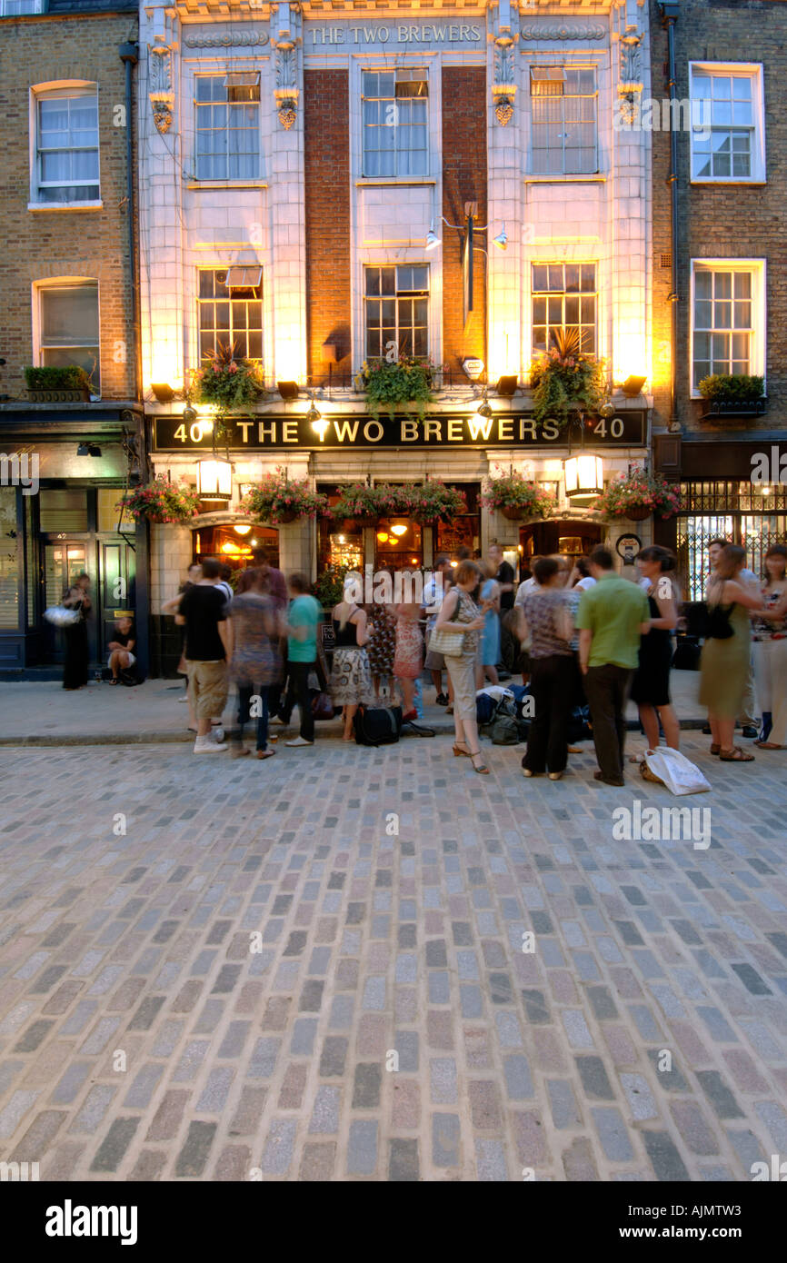 Patrons drinking outside the Two Brewers pub in Covent Garden in London ...