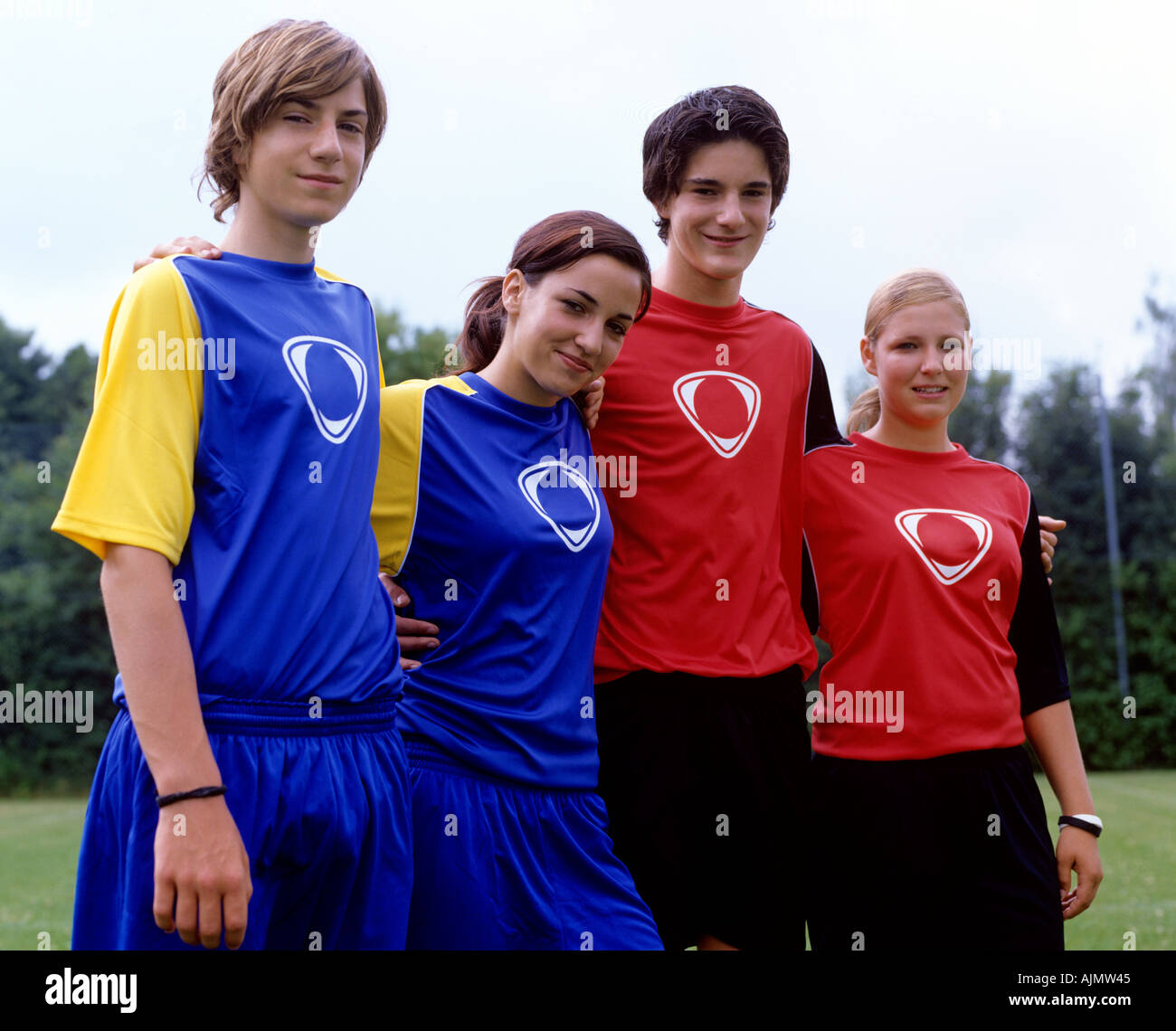 group of friends posing in football kit Stock Photo - Alamy