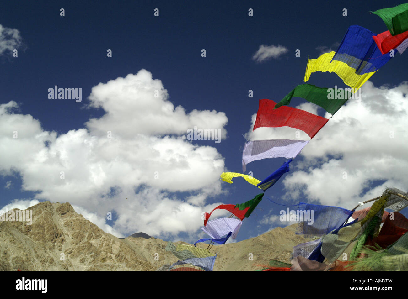 Colourful tibetan buddhist prayer flags flapping wind Himalaya moutains ...