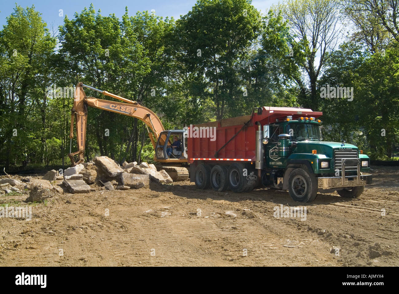 Back Hoe Loading A Dump Truck Lorry At A Construction Site Stock Photo ...