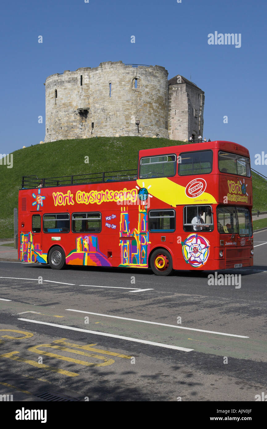 York City sight seeing tour bus travelling past Cliffords Tower in York ...