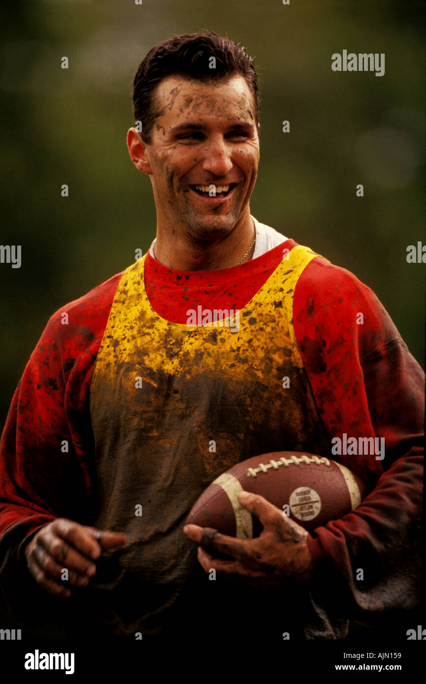 A muddy touch football player is happy after a game Stock Photo - Alamy