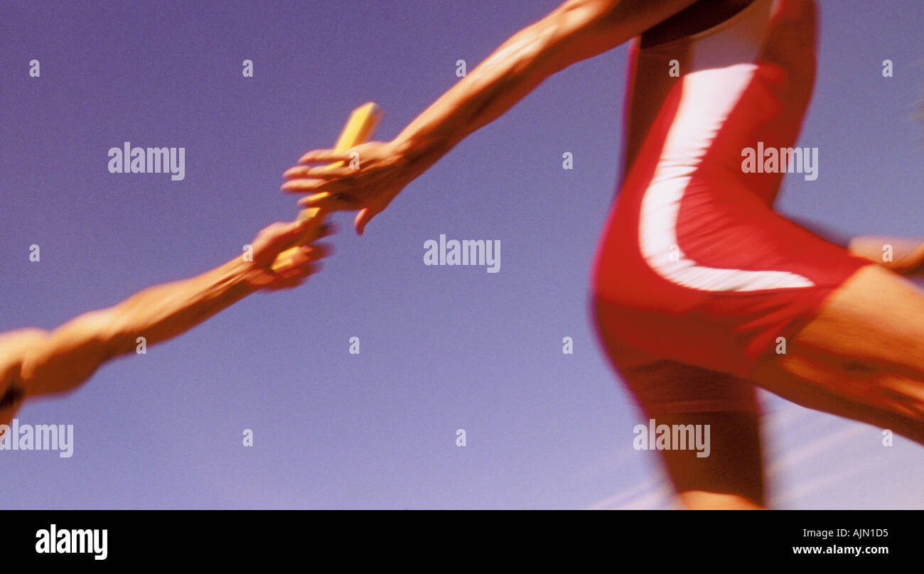 The definitive moment of a relay race passing the baton Stock Photo - Alamy