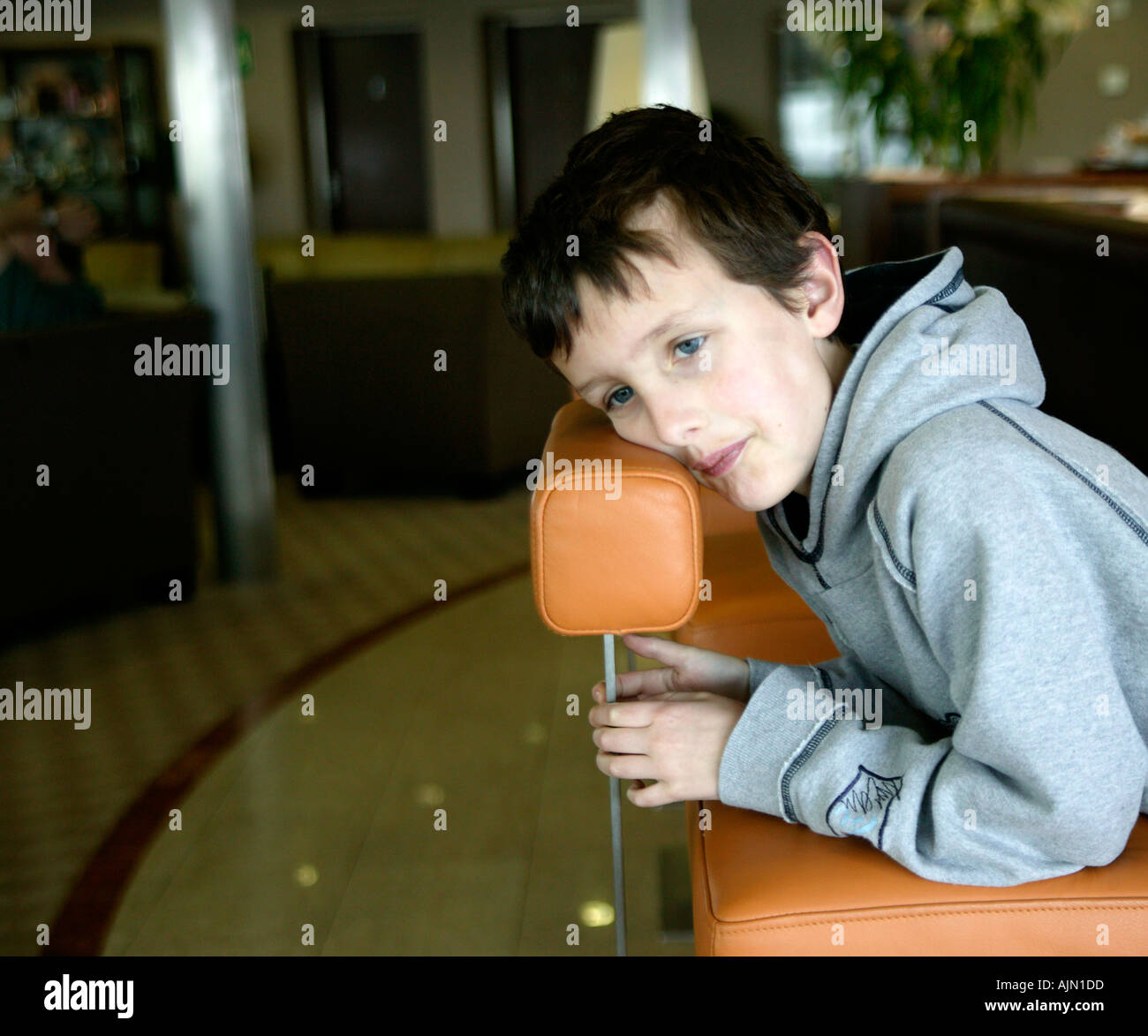 BOY SAT ON BAR STOOL Stock Photo - Alamy