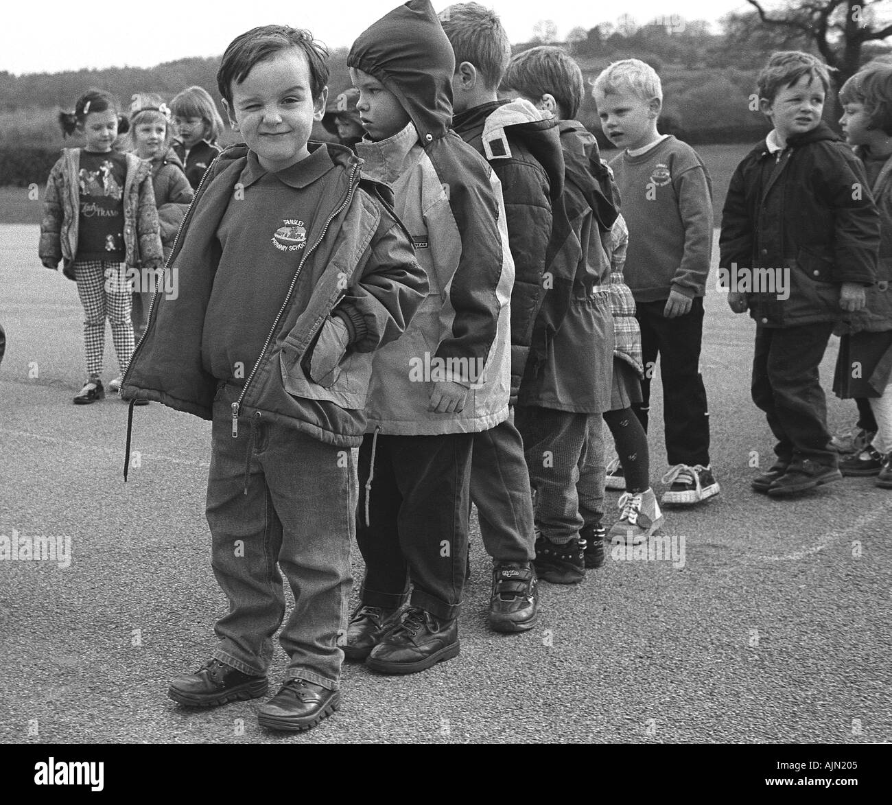 CHILDREN WAITING IN LINE TO ENTER PRIMARY SCHOOL Stock Photo - Alamy