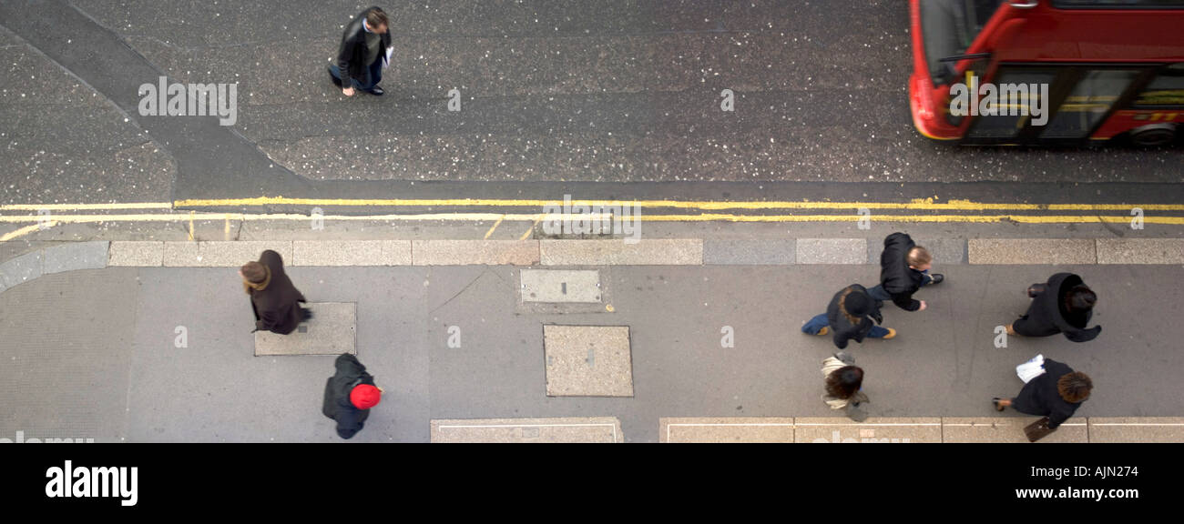 aerial view of commuters and office workers on pavement with bus ...