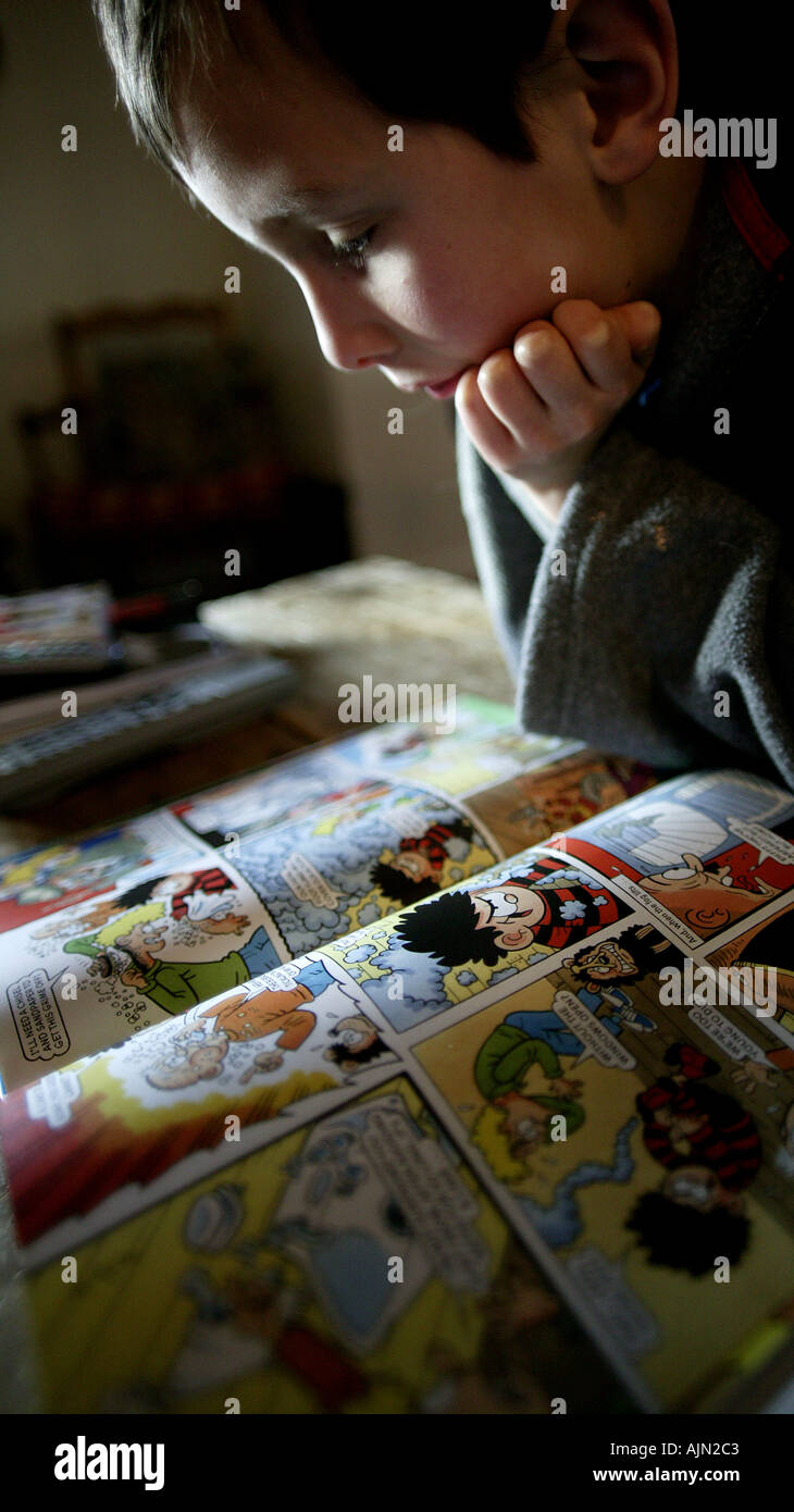 BOY MALE CHILD AGE 7 CAUCASIAN COMIC BOOK READ READING CONCENTRATE ...