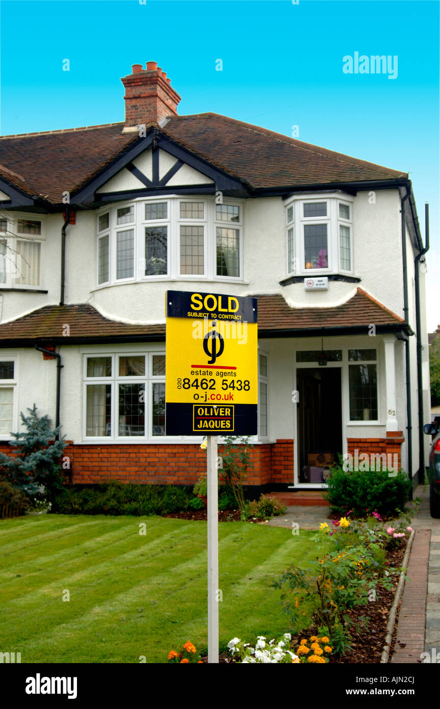 sold estate agent sign outside house london Stock Photo - Alamy